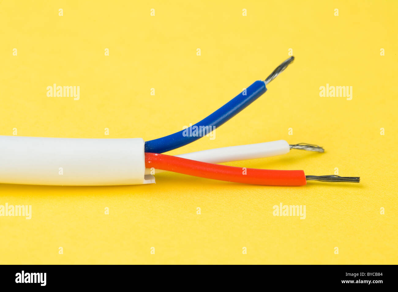 Electrical wire with yellow background Stock Photo - Alamy