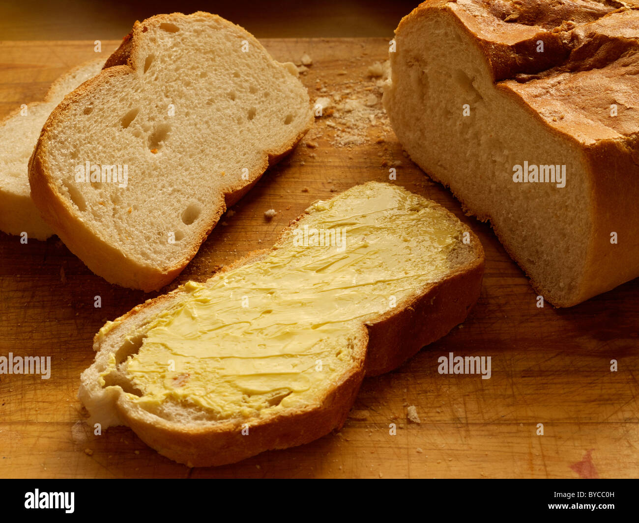 Sliced White bread, with one buttered and half a unsliced loaf Stock ...