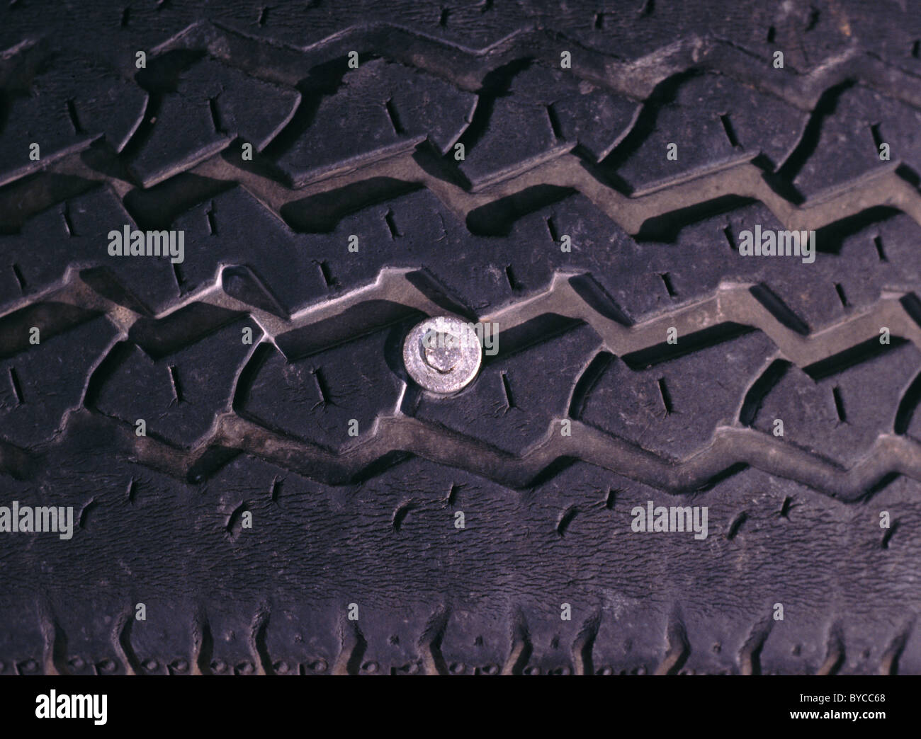 nail in an automobile flat tire Stock Photo - Alamy