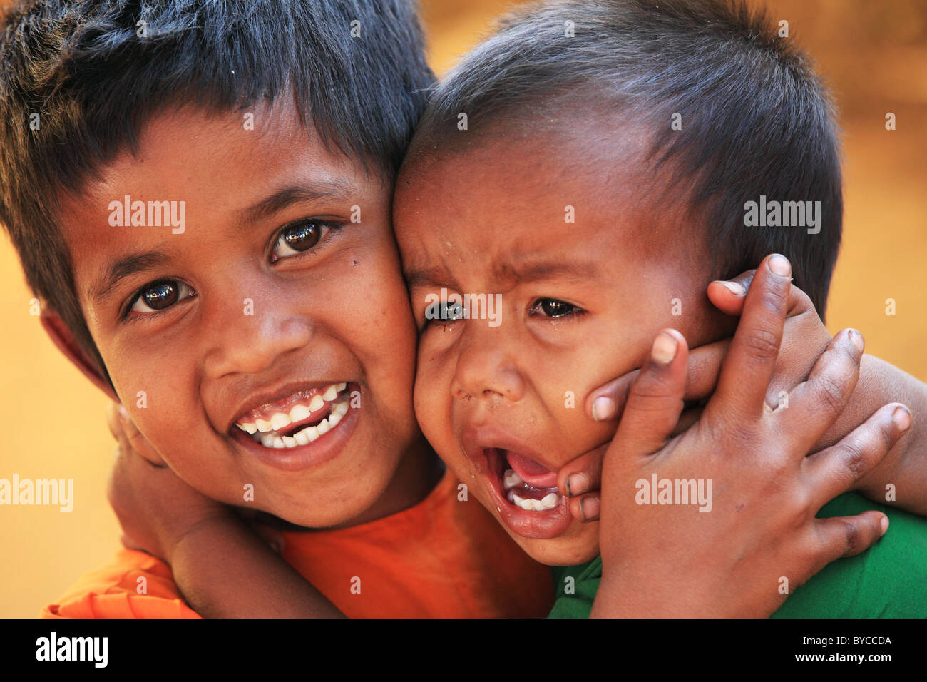Boy crying in his sister's arms Andhra Pradesh South India Stock Photo ...