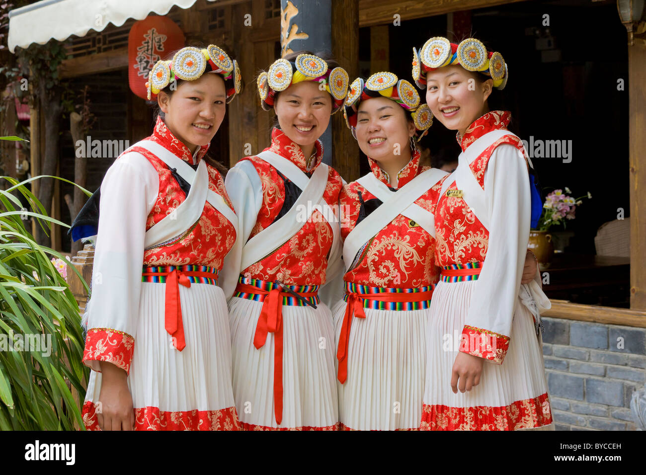 Four young Naxi women in traditional costume in Lijiang old town ...