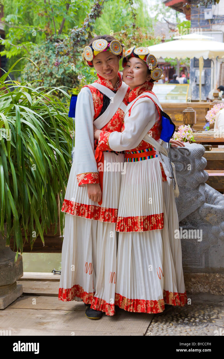 Two young Naxi women in traditional costume in Lijiang old town, Yunnan ...