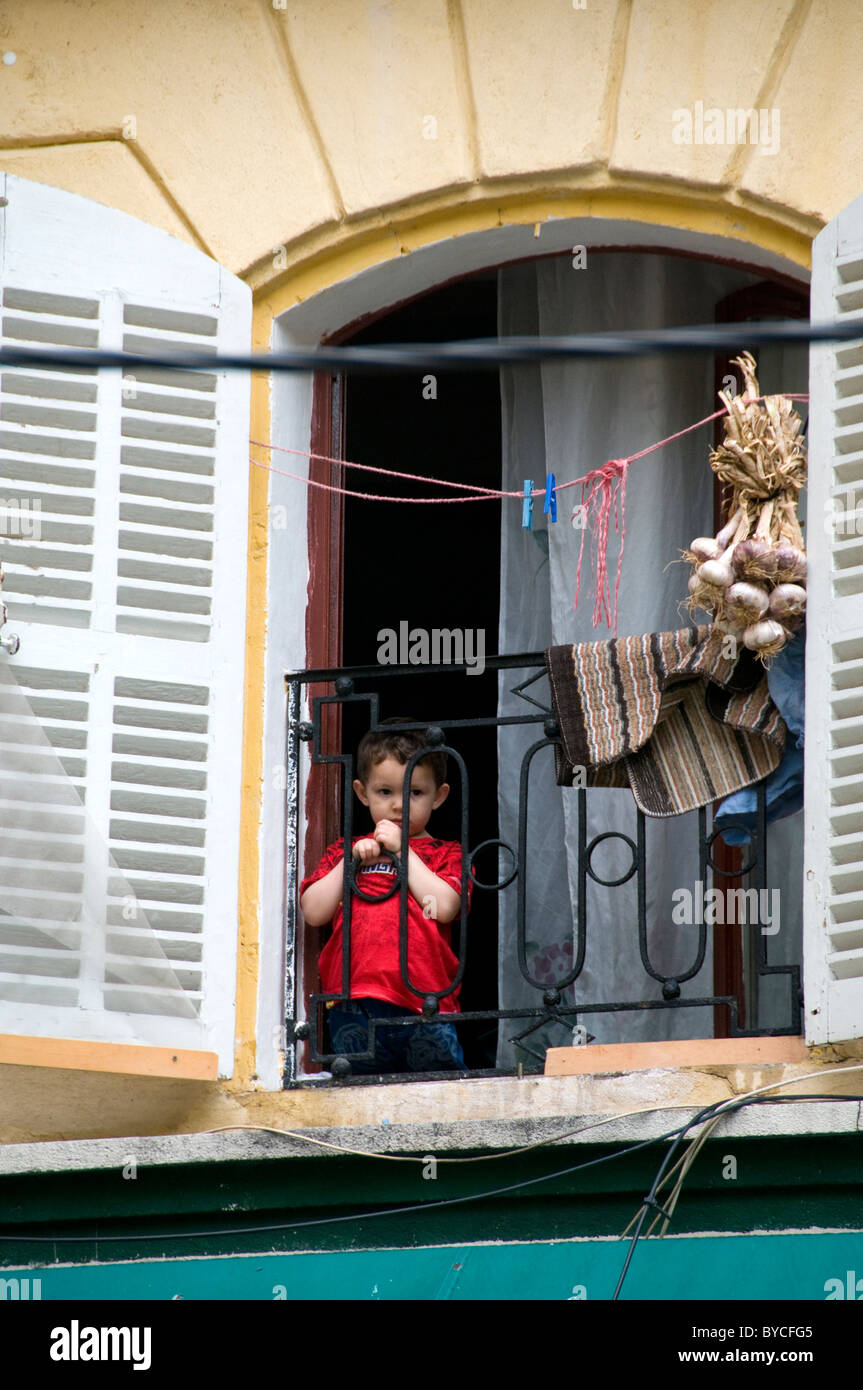 W10935 Boy in window Stock Photo - Alamy