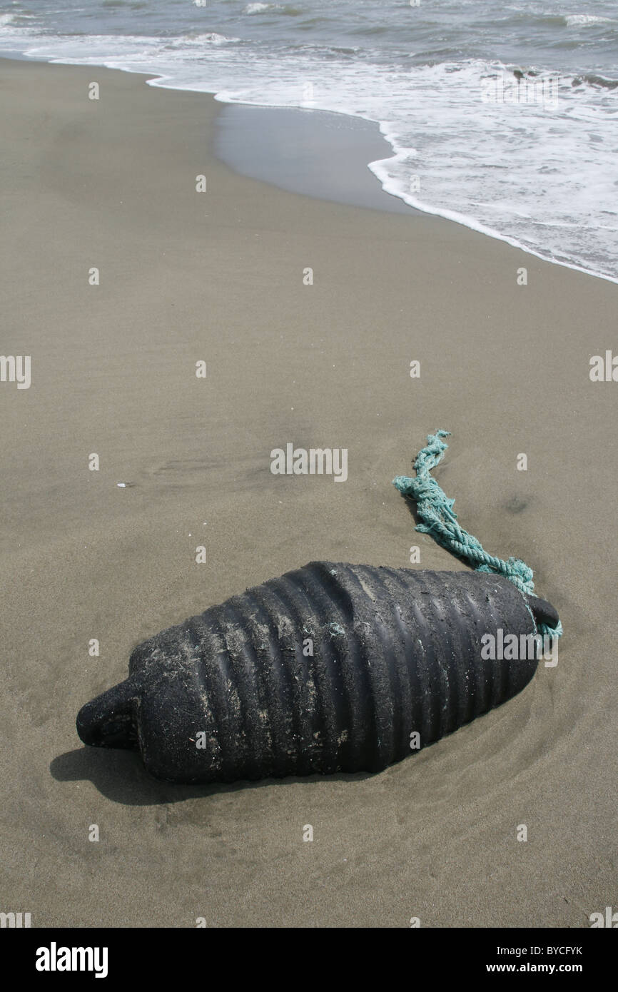 buoy washed up on sand coast shore by sea Stock Photo - Alamy