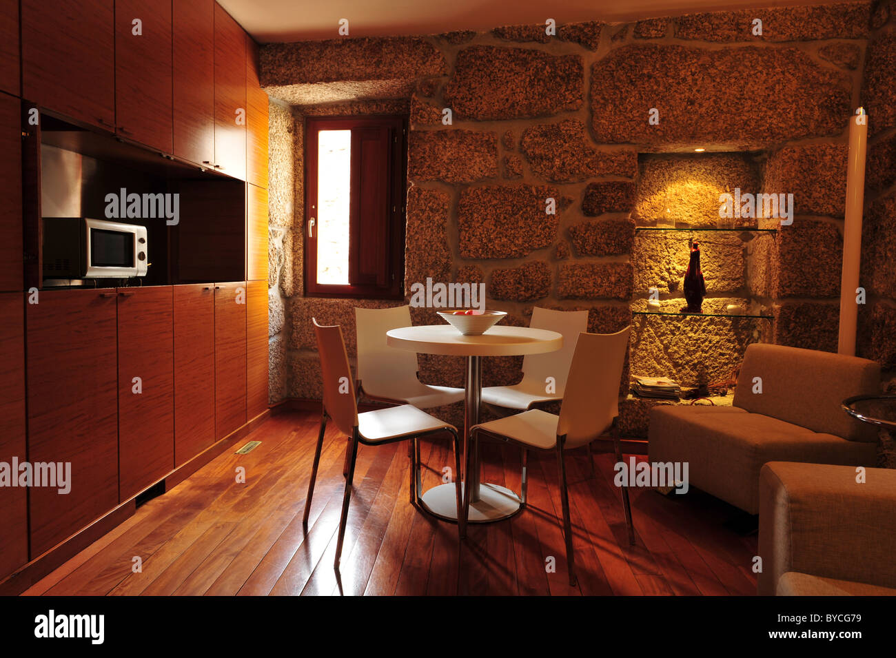 Kitchenette with round table and four chairs Stock Photo - Alamy