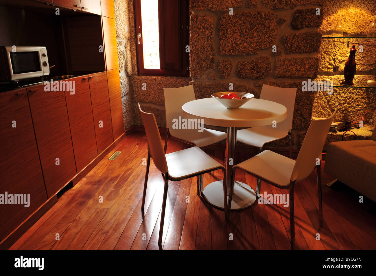 Kitchenette with round table and four chairs Stock Photo - Alamy