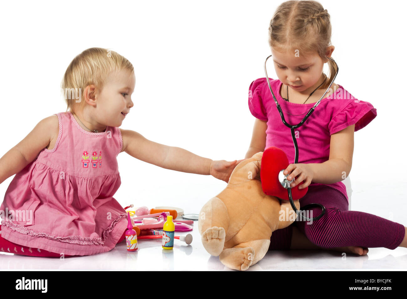 Children playing doctor with a doll isolated on white Stock Photo - Alamy