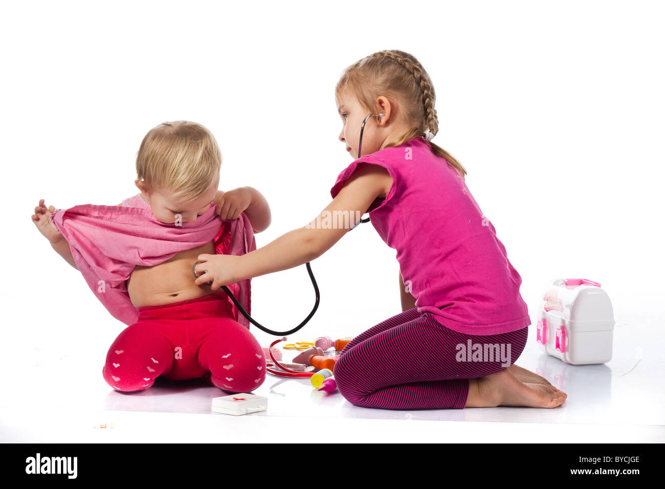 Children playing doctor with a doll isolated on white Stock Photo - Alamy