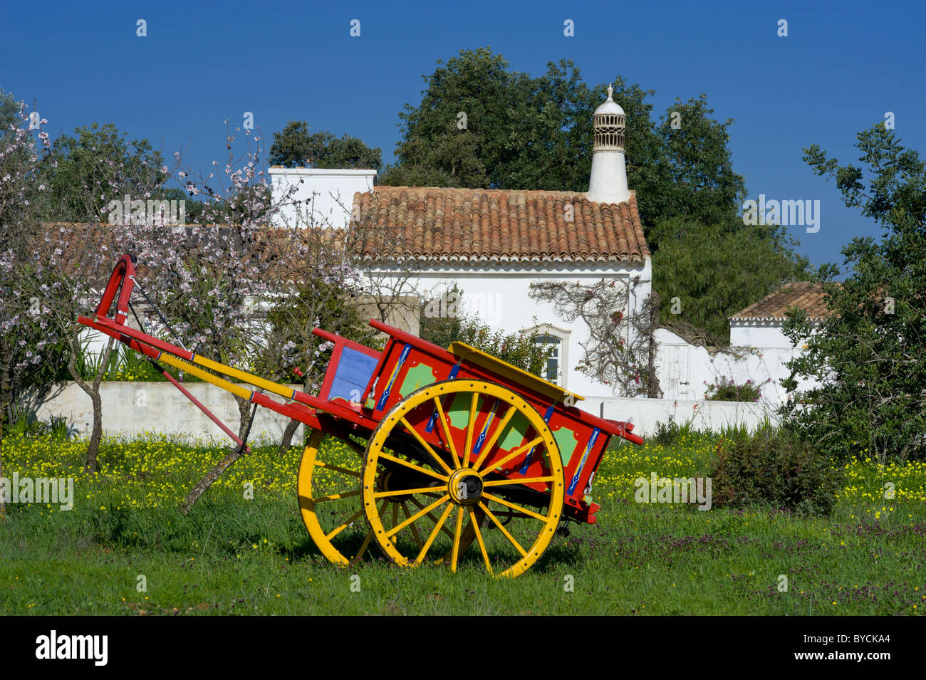 Portugal, the Algarve, rustic painted cart outside farmhouse Stock ...