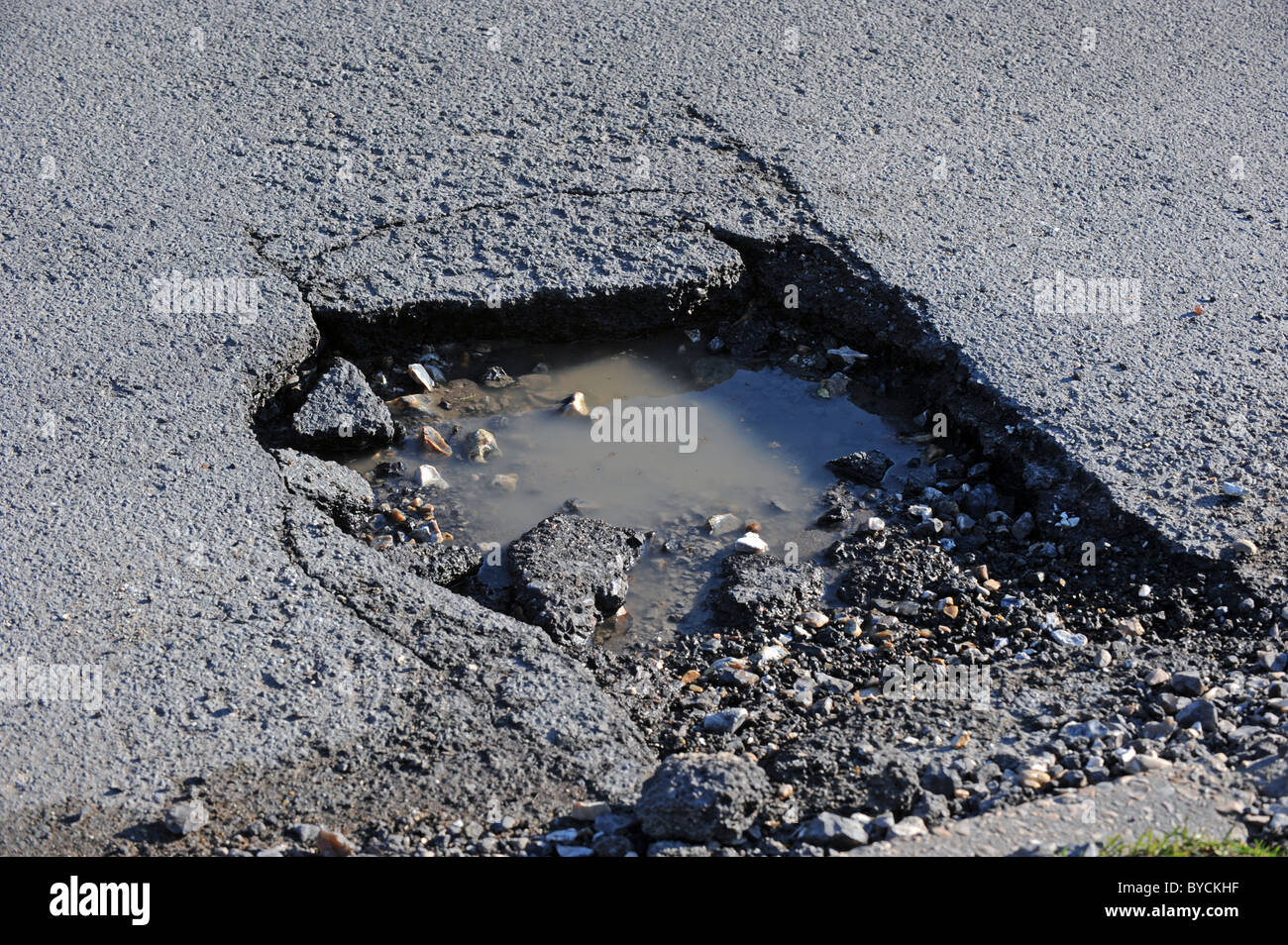 Deep potholes in a busy road caused by the recent snow and freezing ...