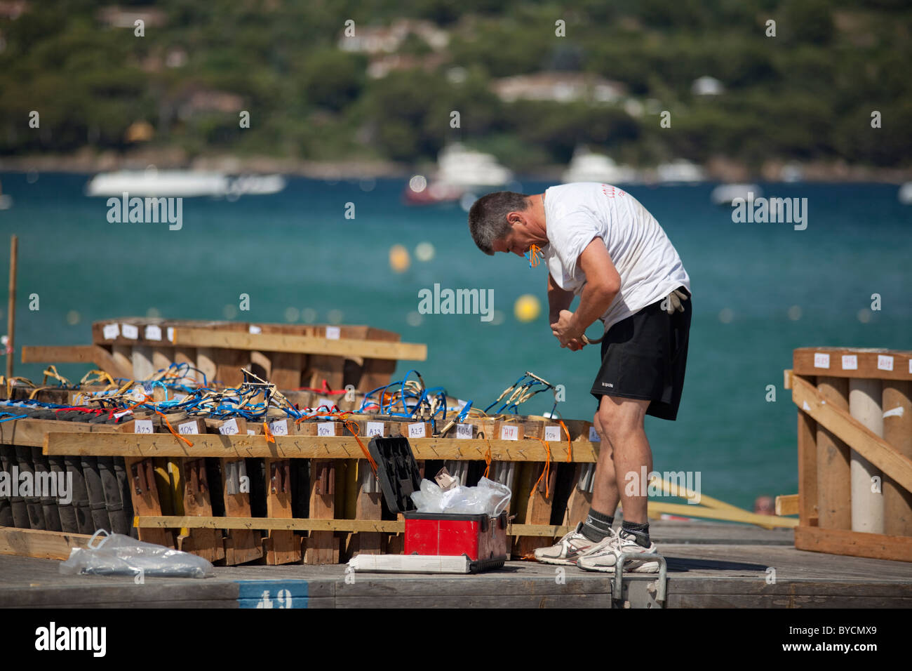 Man installing firework bombs on a floating raft. Getting ready for the ...