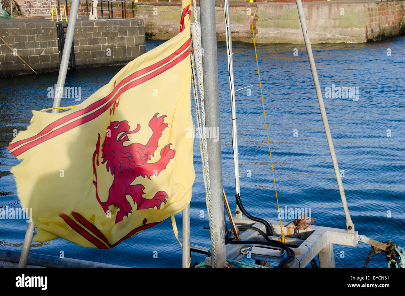 Scottish flag (Lion Rampart) on a fishing boat in Dunbar Harbour, East ...