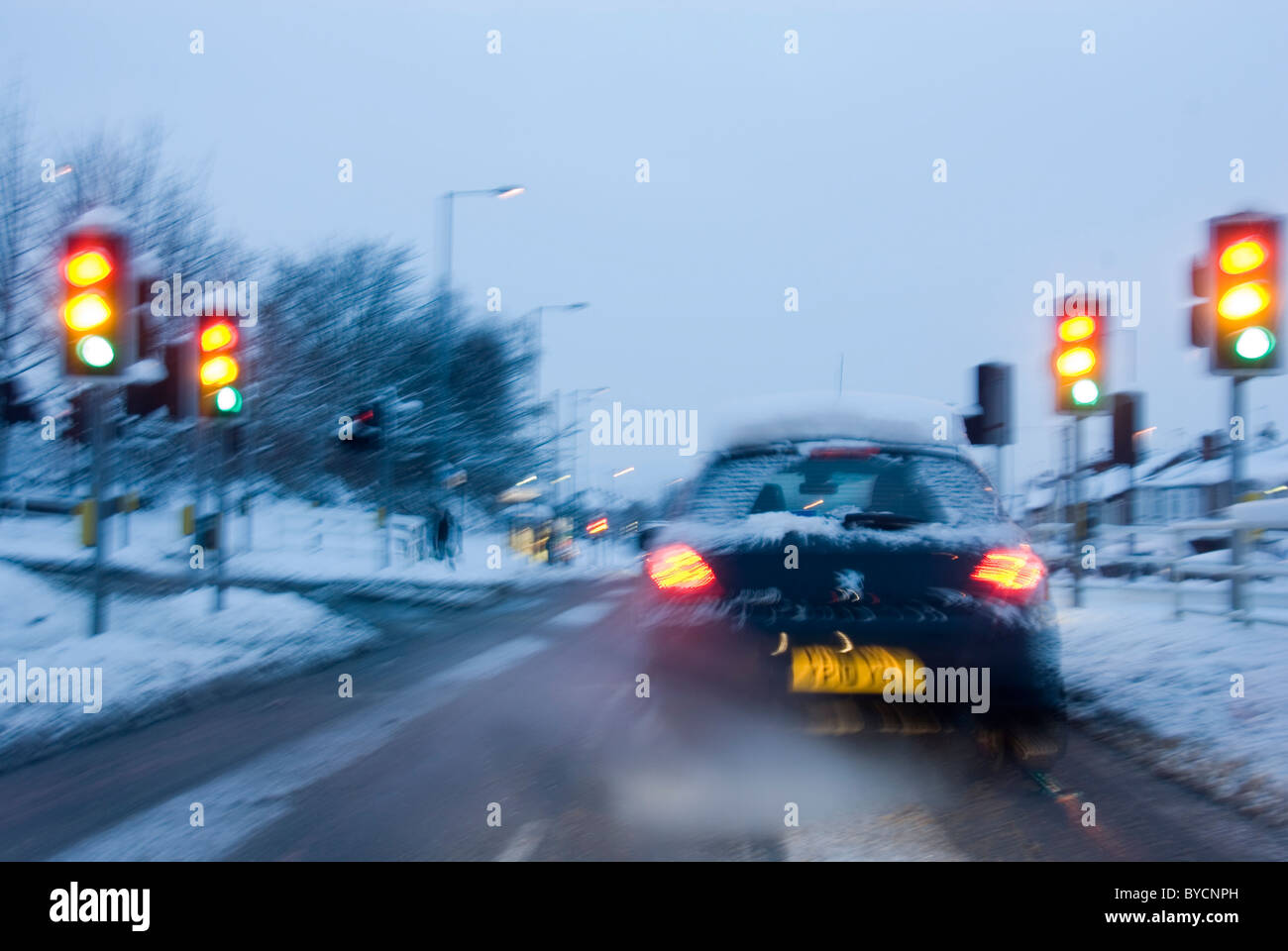 Cars On City Street Driving Past Traffic Lights in Snow With Motion ...