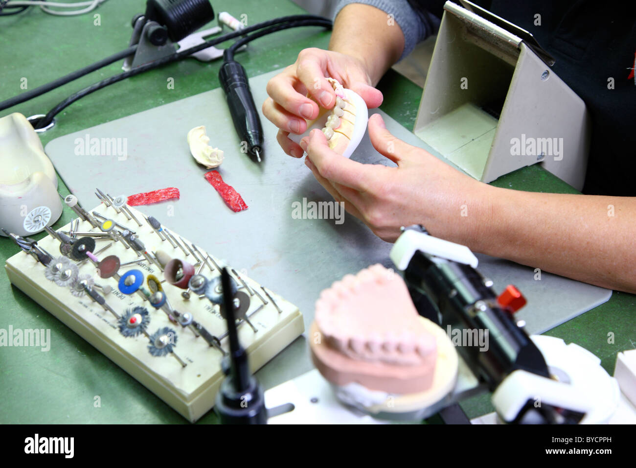 Dental laboratory, dental technician at work, making of tooth bridges ...