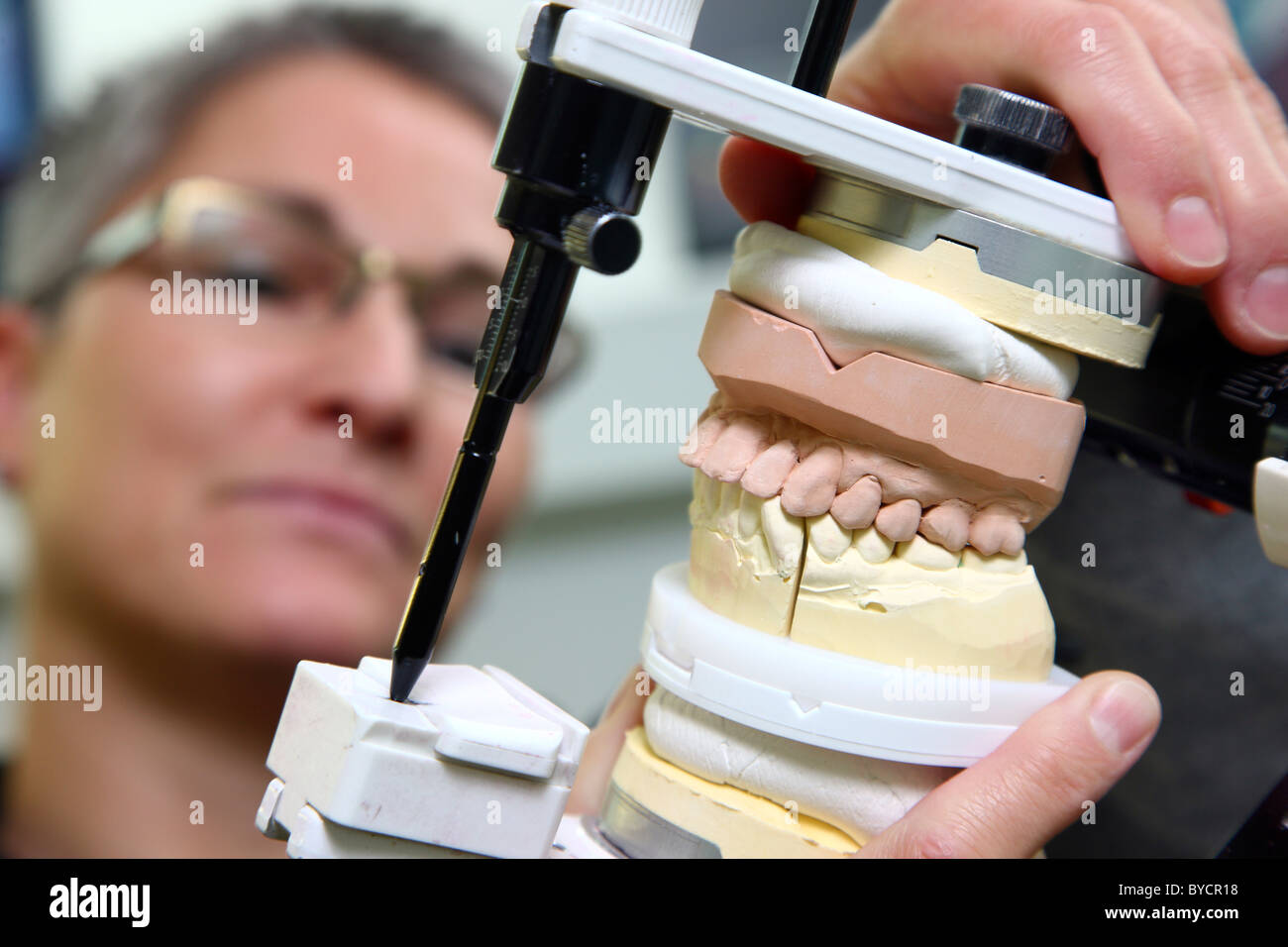 Dental laboratory, dental technician at work, making of tooth bridges ...