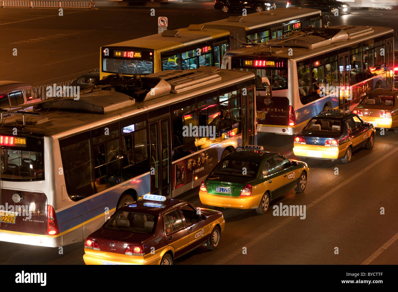 Beijing buses and taxis at night at the junction of Jianguomen Inner ...