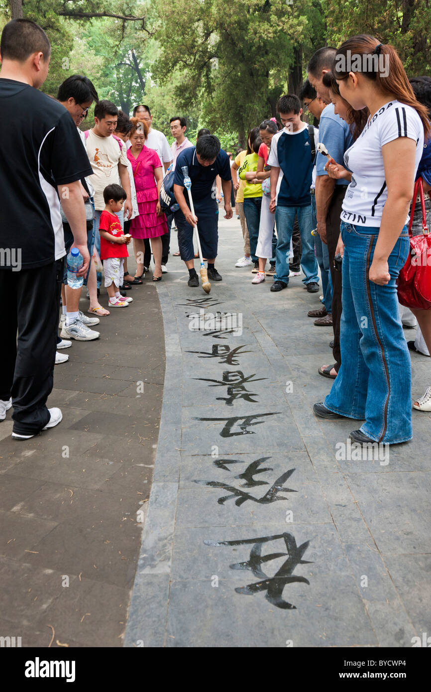 Chinese man practicing street calligraphy in the grounds of the New ...