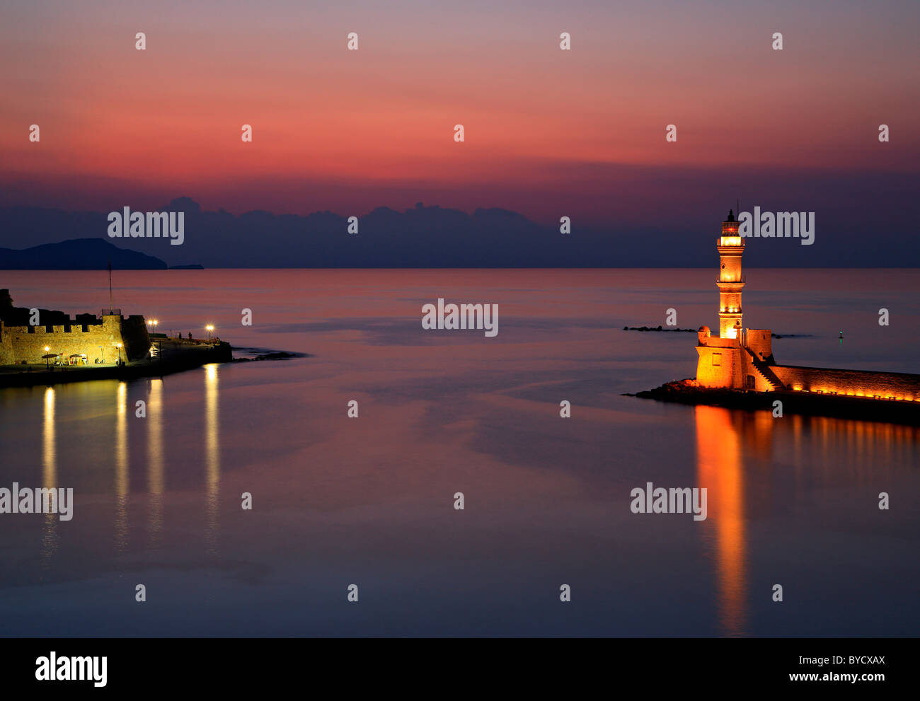 The entrance of the old Venetian harbor of Hania after sunset. Crete ...
