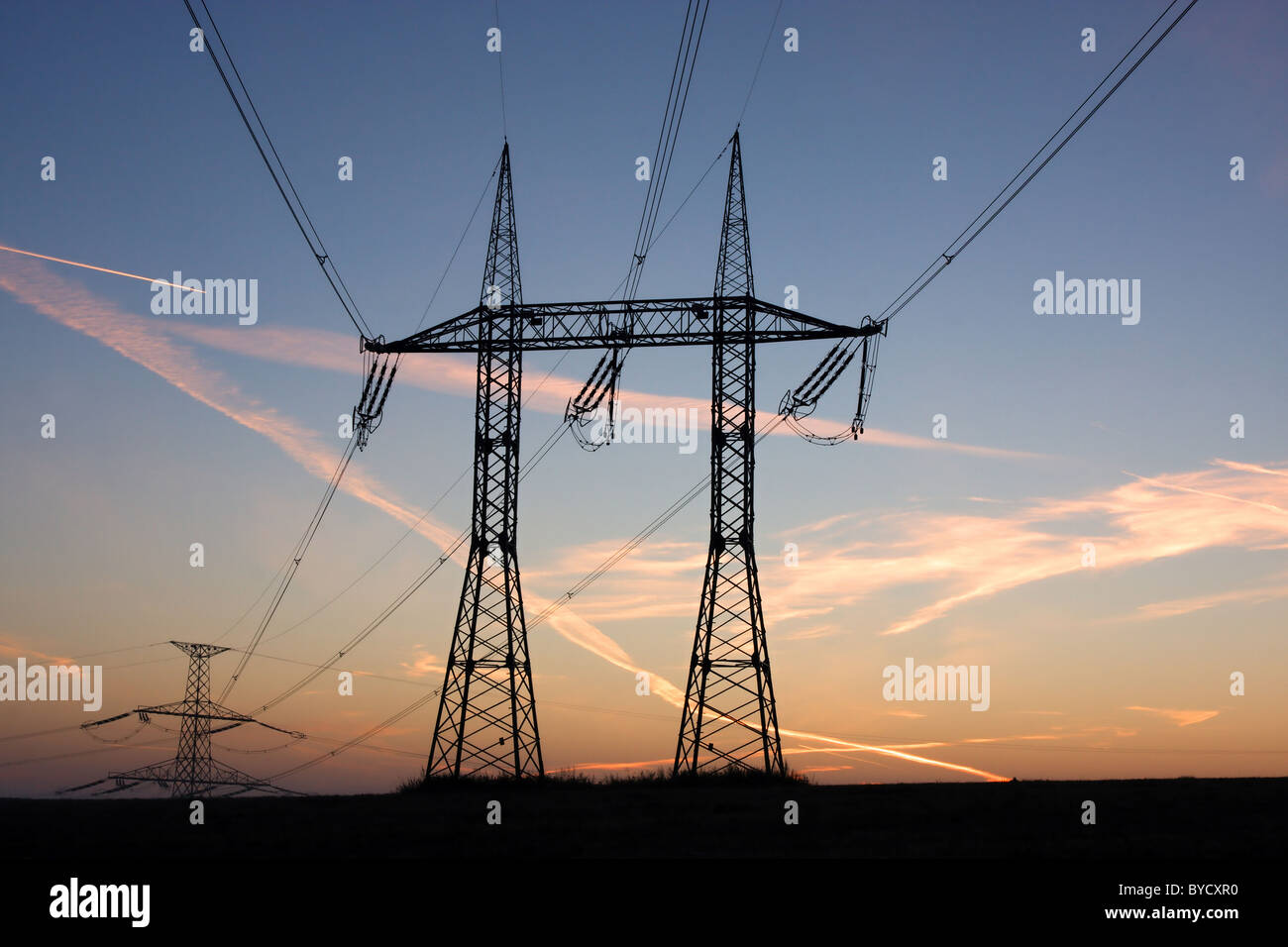 High voltage electricity pylons over sky Stock Photo - Alamy
