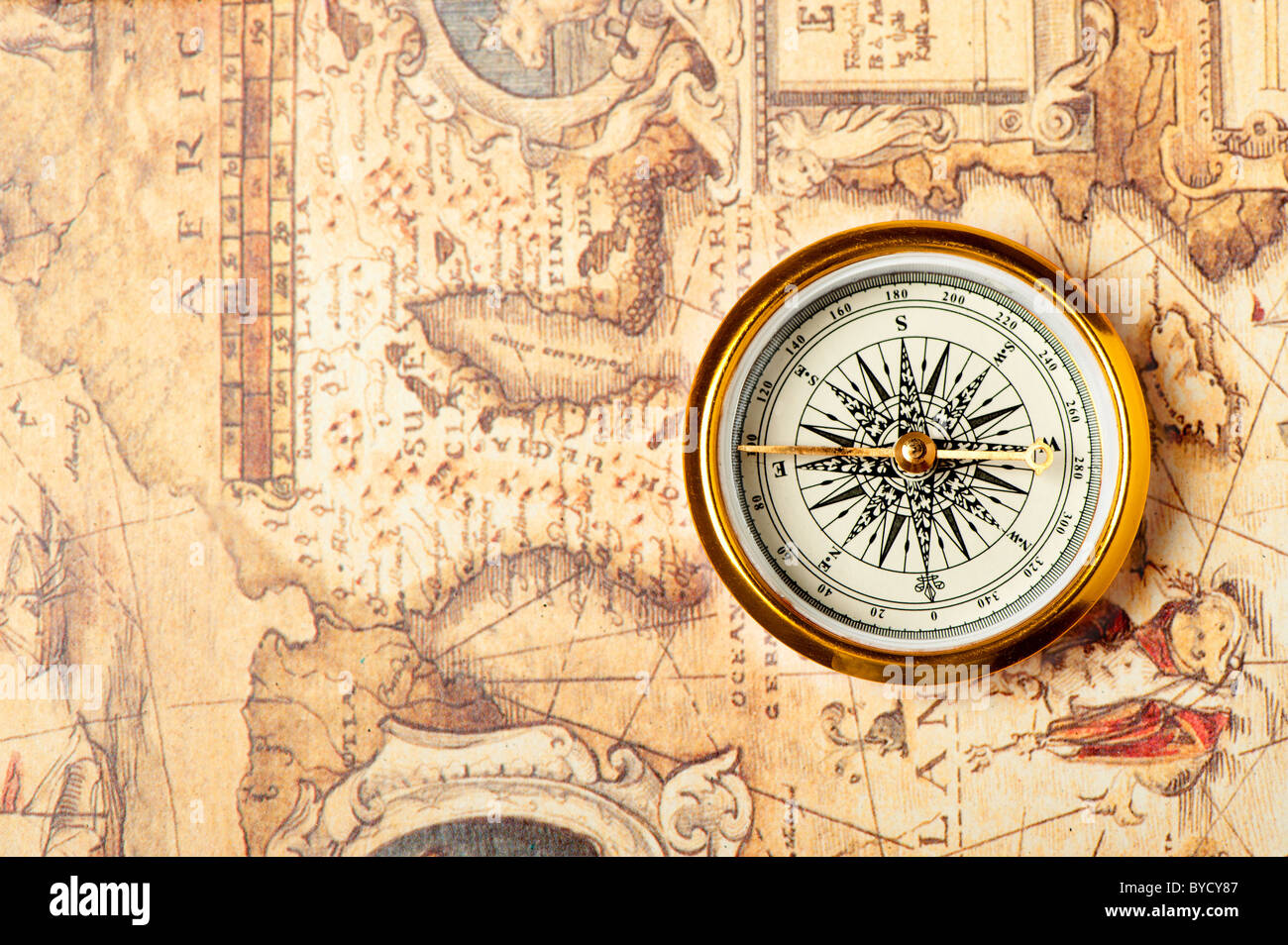 Old compass on ancient map. A compass with the antique image of a ...