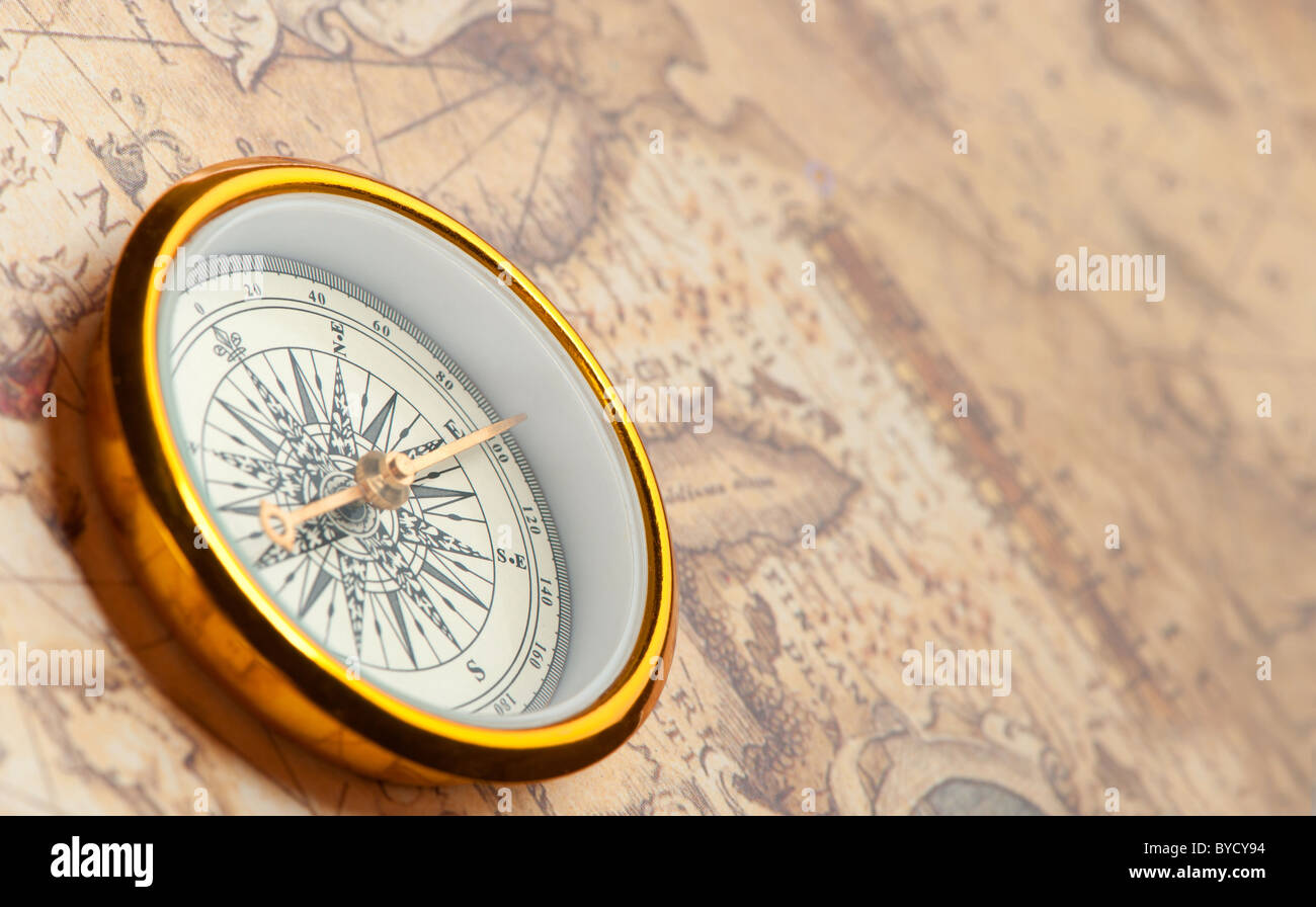 Old compass on ancient map. A compass with the antique image of a ...