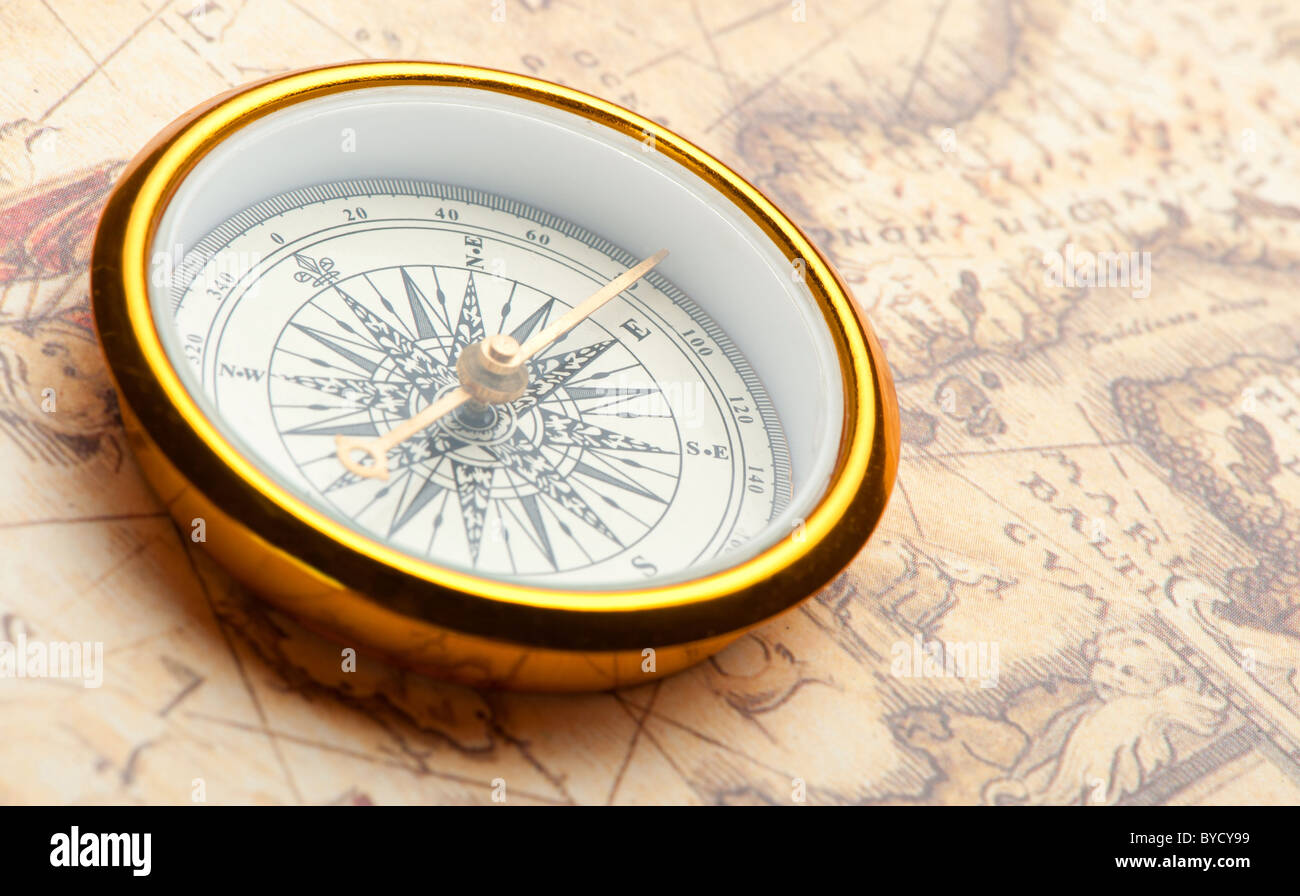 Old compass on ancient map. A compass with the antique image of a ...