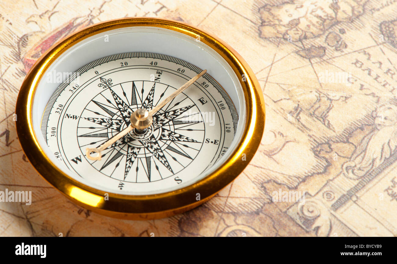 Old compass on ancient map. A compass with the antique image of a ...