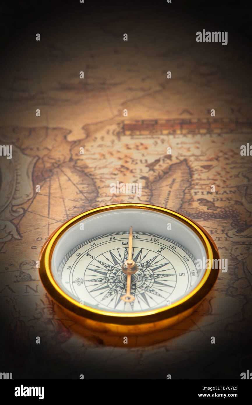 Old compass on ancient map. A compass with the antique image of a ...