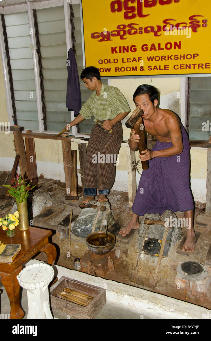 Myanmar (aka Burma), Mandalay. Gold leaf workshop, men beating gold ...