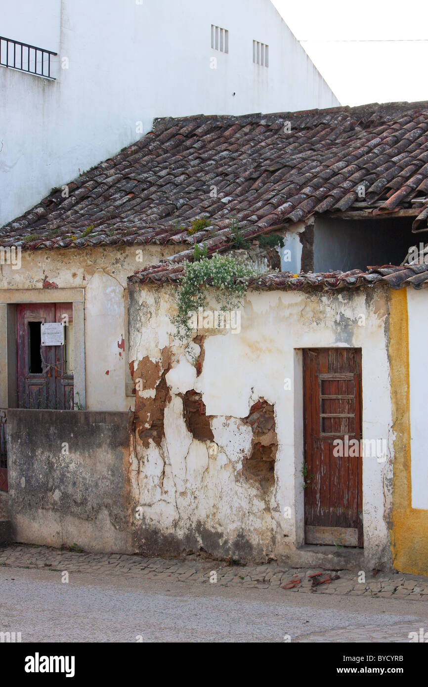 A ruined derelict old building that is falling down and the roof has ...