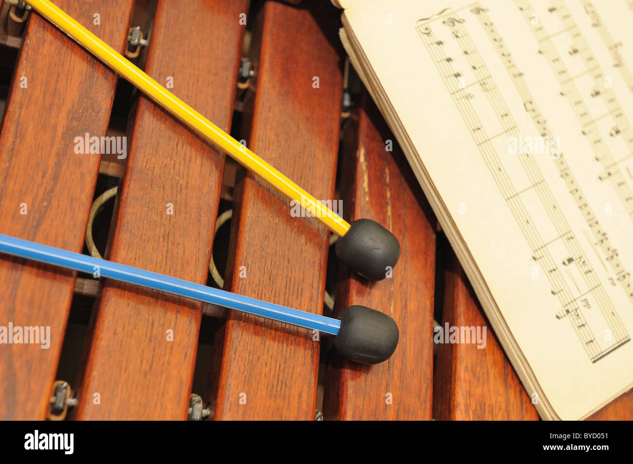 Wood xylophone with notes and mallets. A photo close up. Original color ...