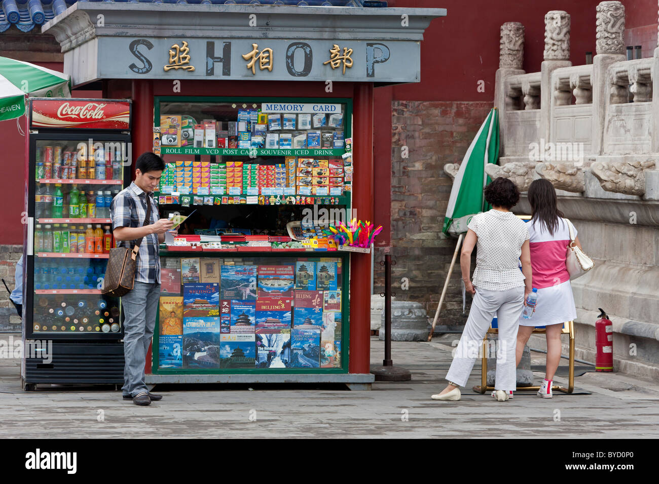Tourist shoppers at convenience store kiosk outside the Temple of ...