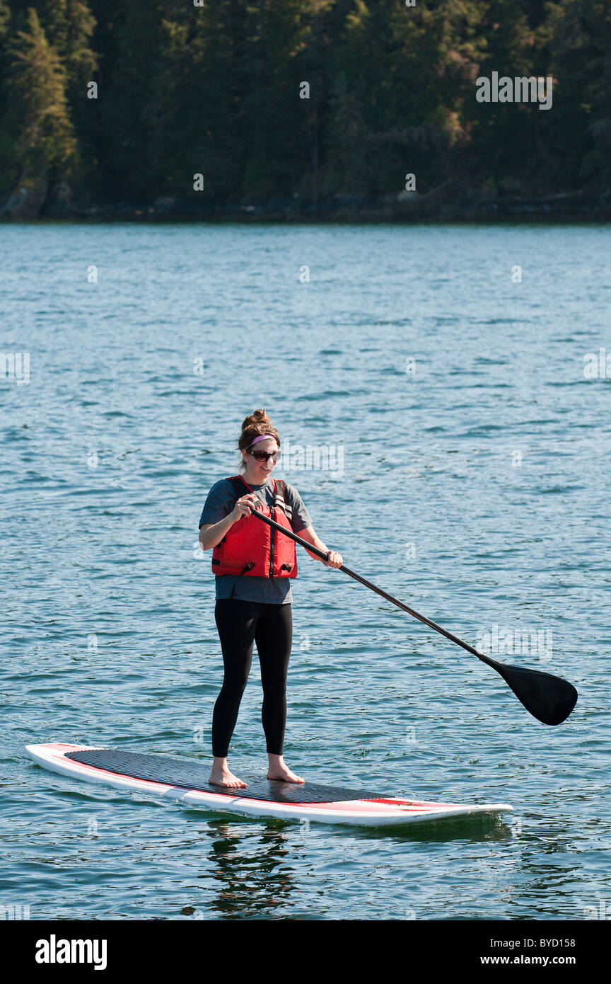 Young woman paddleboarder paddleboarding in Windham Bay in the Chuck ...