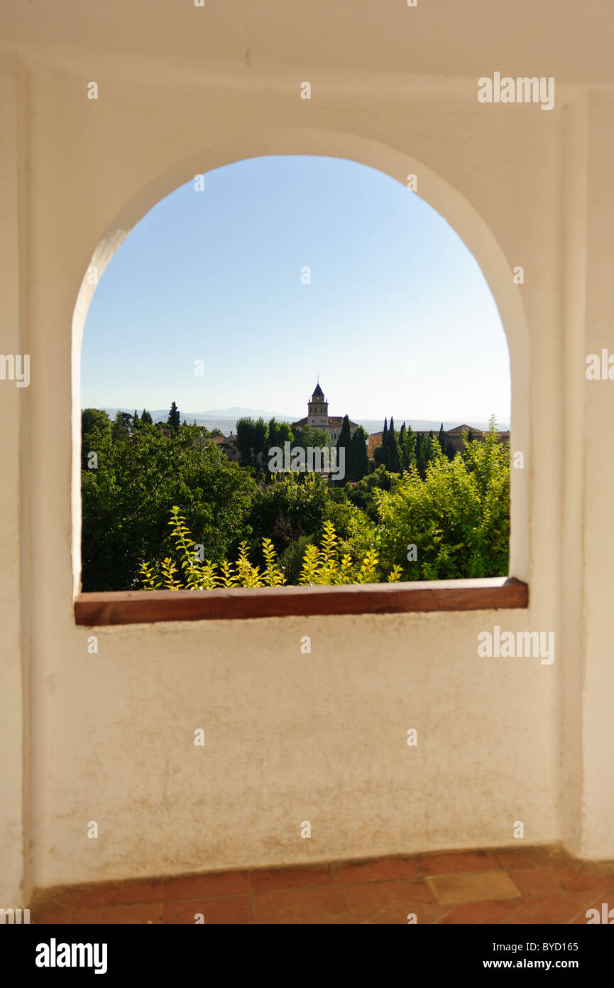 The Alhambra framed by a decorative arched window as seen from the ...
