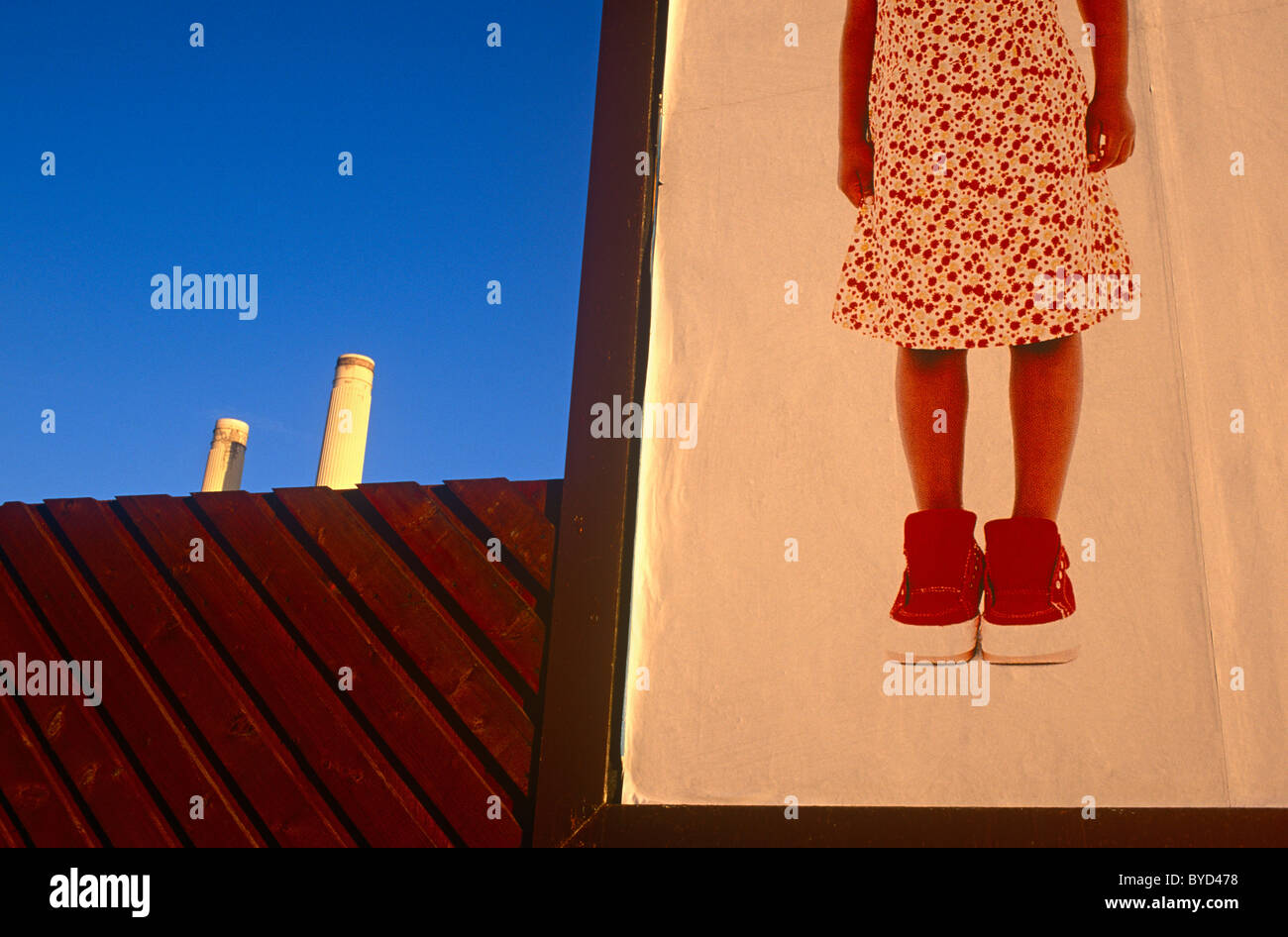 The legs of a young girl appear of an ad billboard, echoing two of the ...