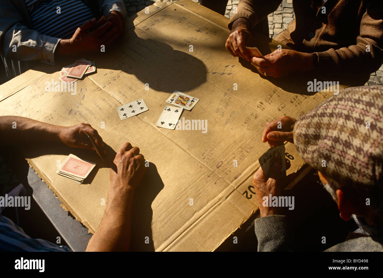 Old men playing cards at table hi-res stock photography and images - Alamy
