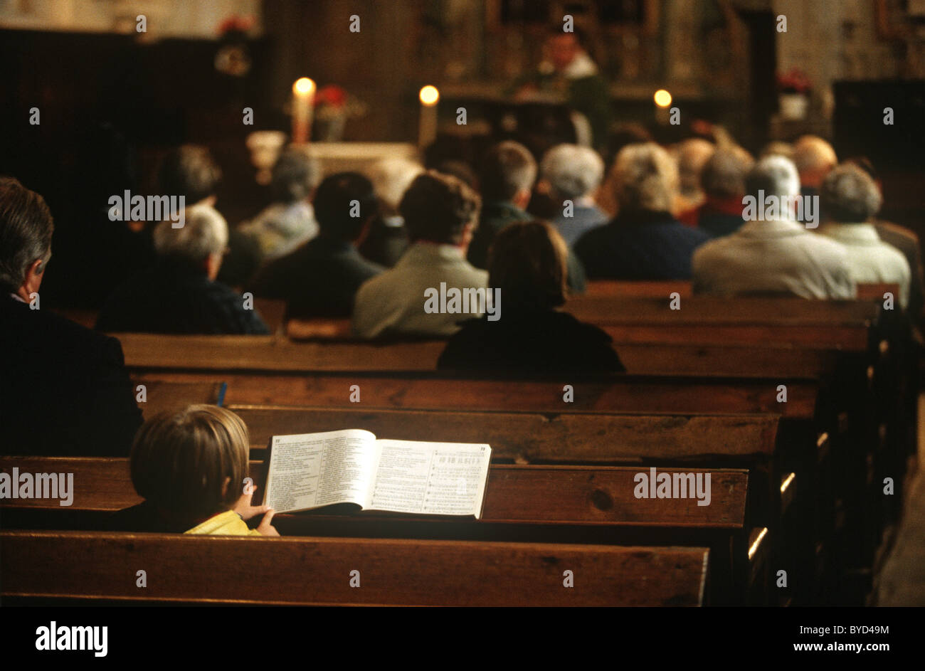 Young boy reads prayers and hymns in a local parish Catholic church ...