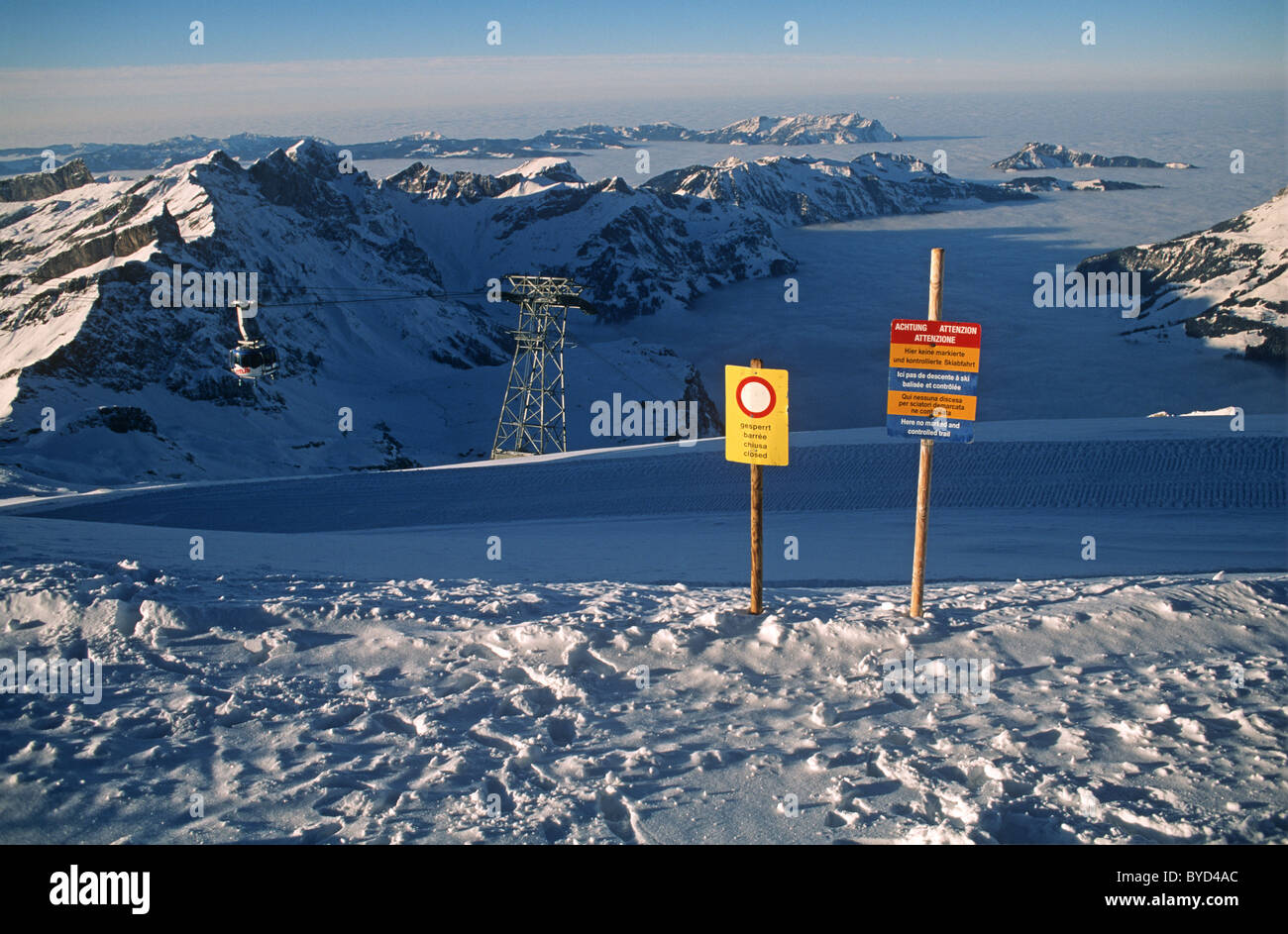 A warning sign on alpine mountain top for skiers, telling them of a ...