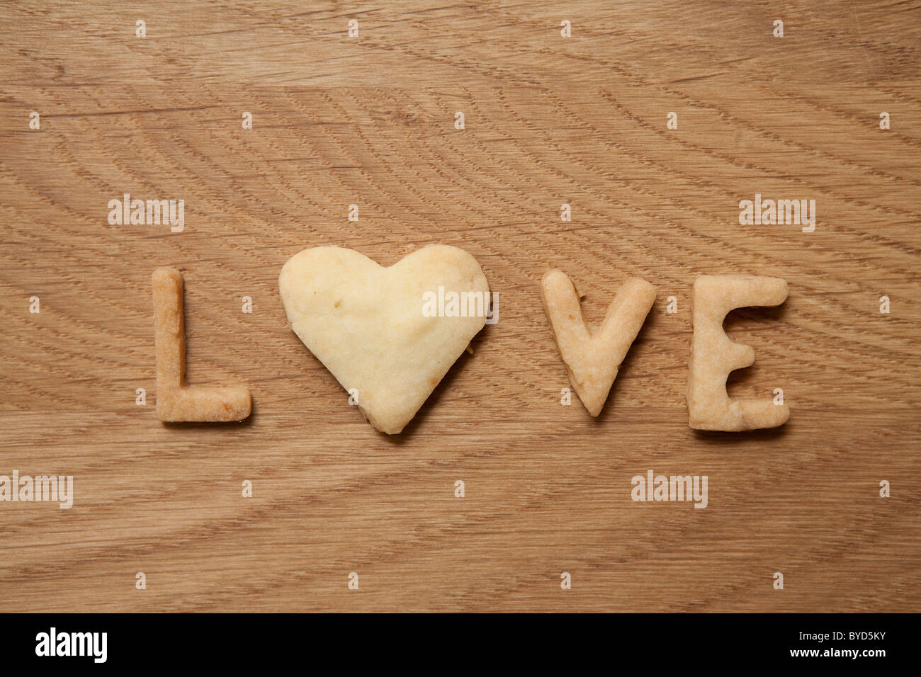 Love, word written with biscuits, with a heart-shaped O Stock Photo - Alamy