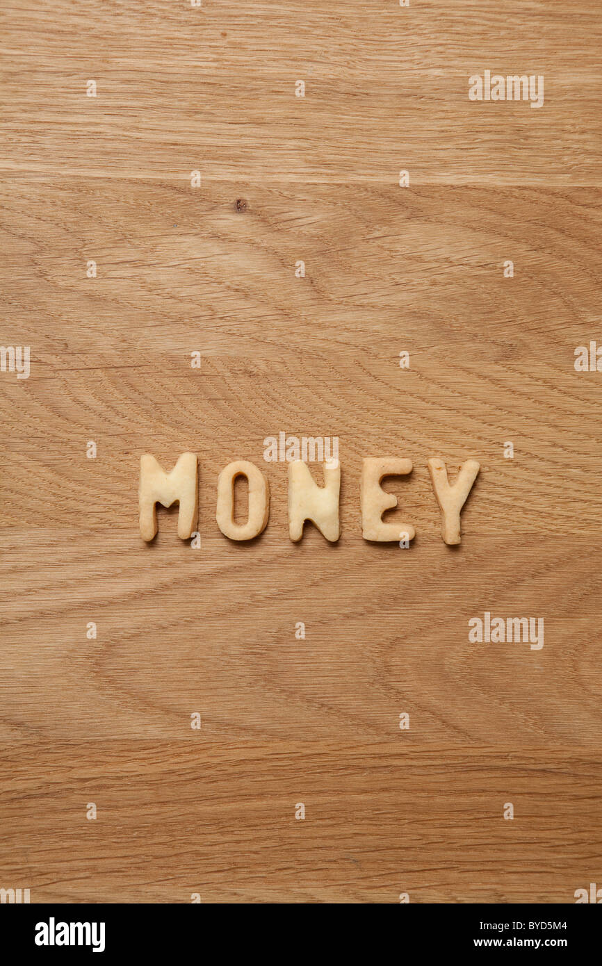 Money, word written with biscuits Stock Photo - Alamy
