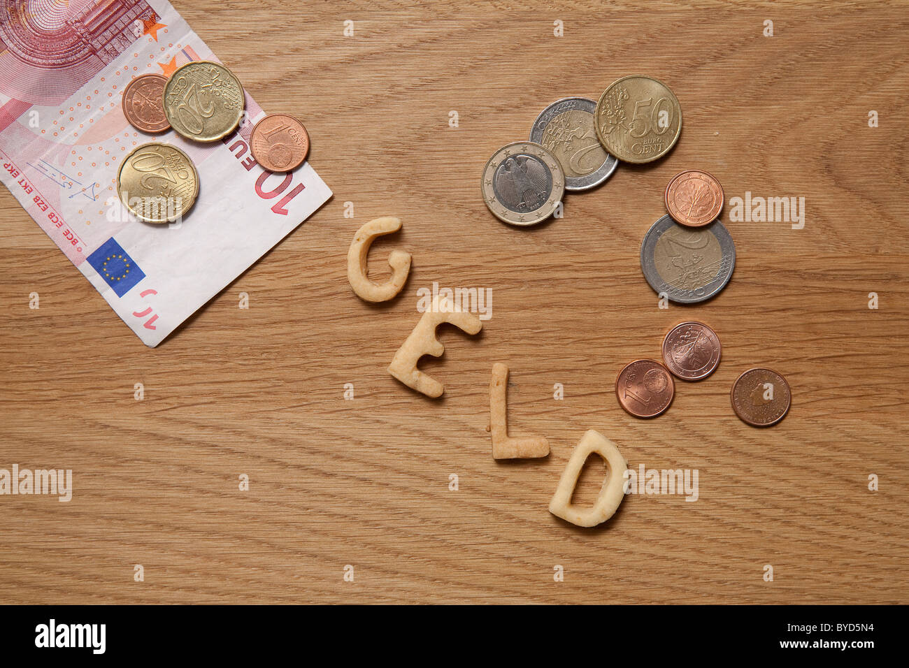Geld, German for money, word written with biscuits, beside coins and a ...