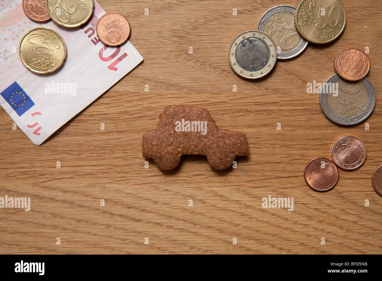 Car biscuit beside coins and a banknote Stock Photo - Alamy
