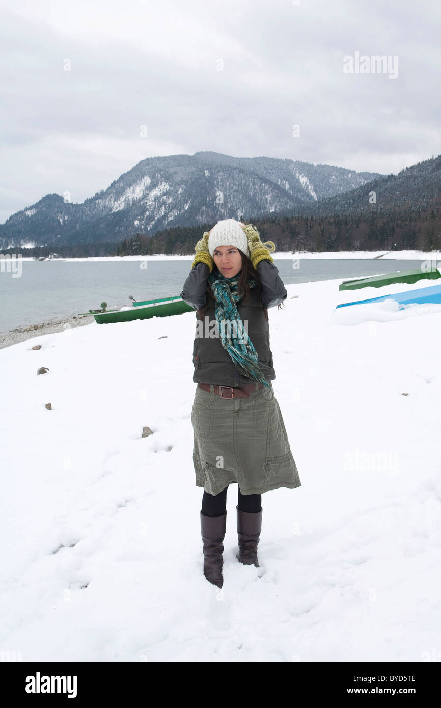 Young woman on the lakeshore of Walchensee or Lake Walchen, winter ...