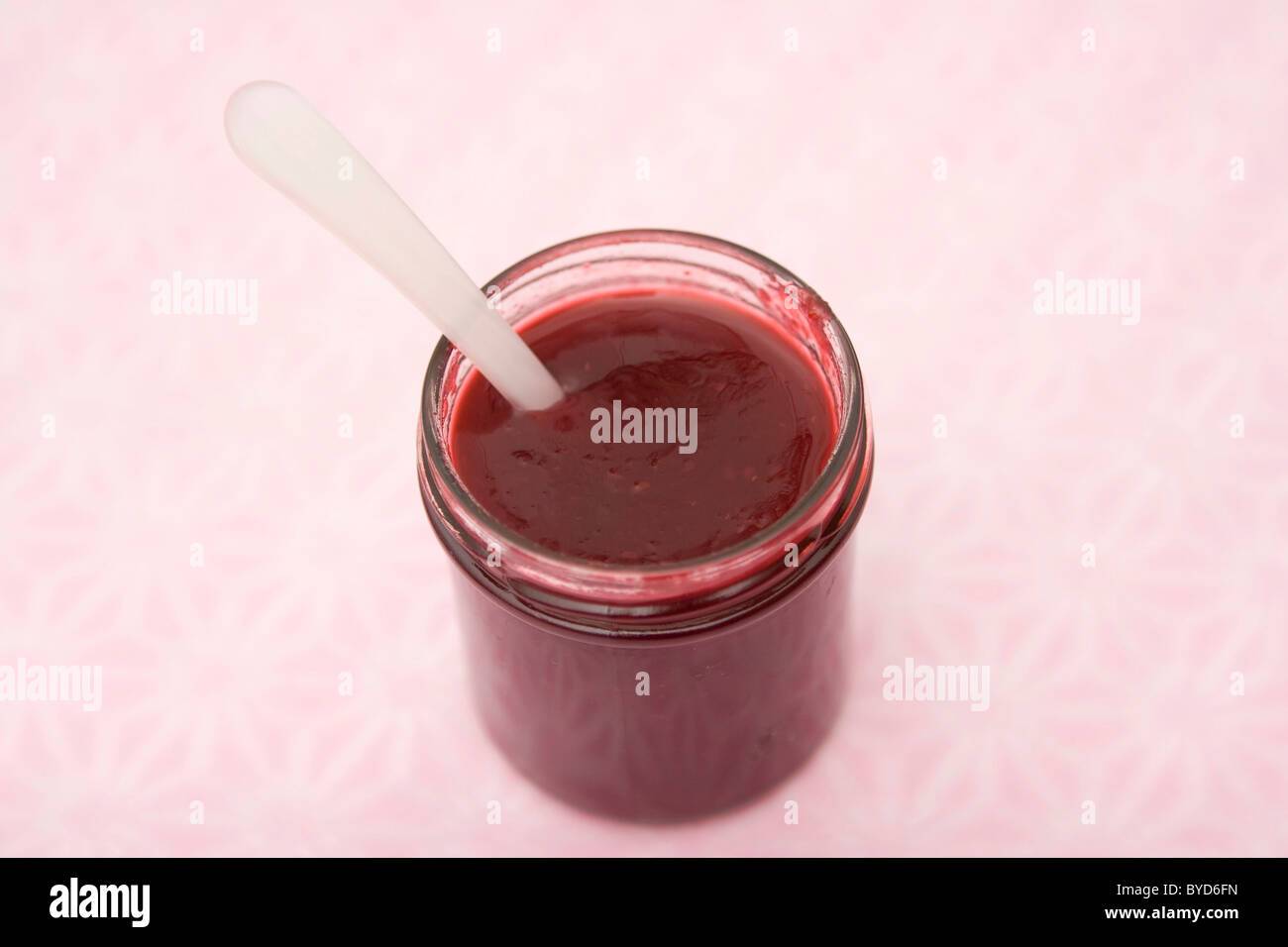 Raspberry jam with spoon Stock Photo - Alamy