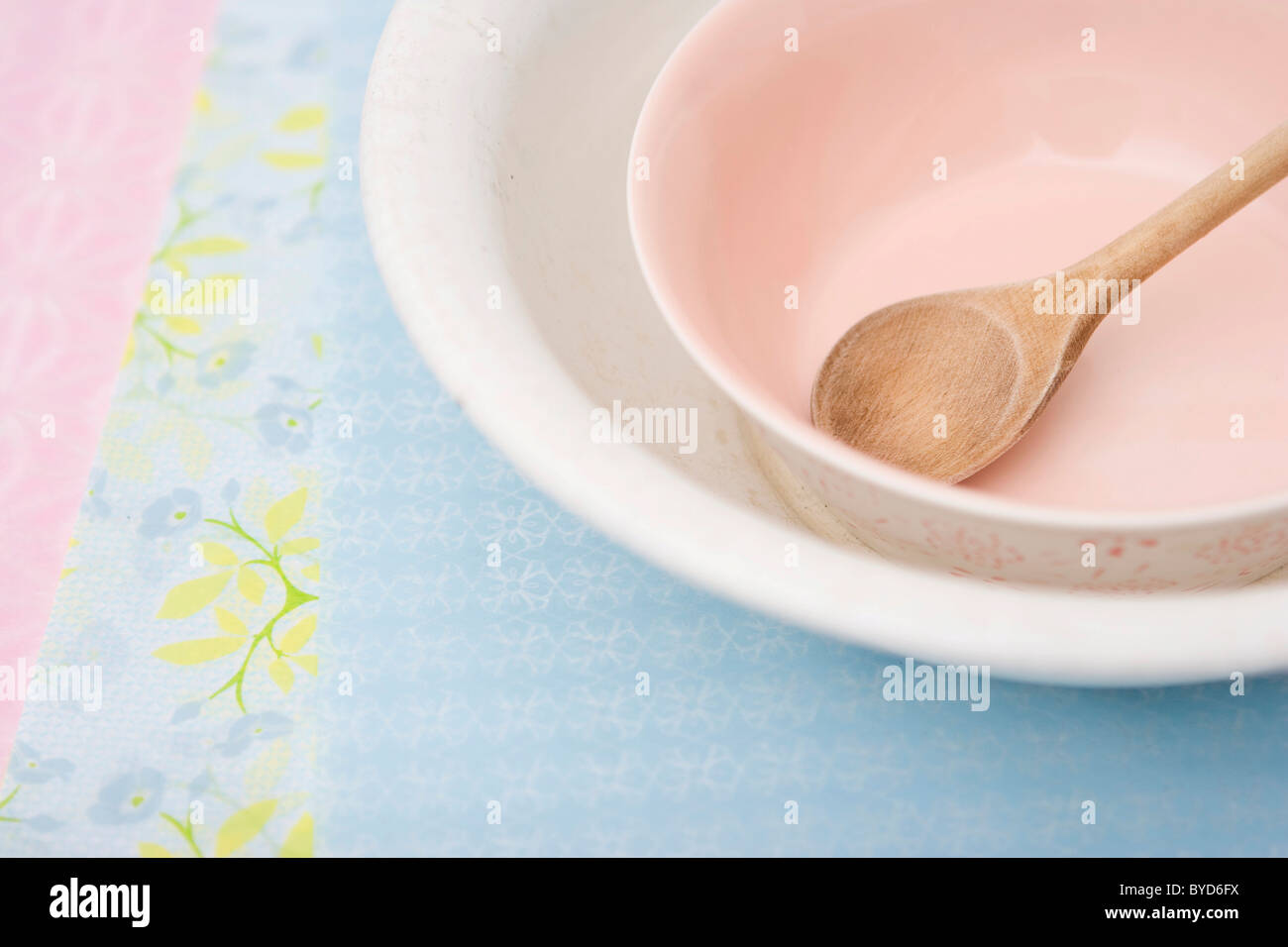 Wooden spoon in two bowls Stock Photo - Alamy