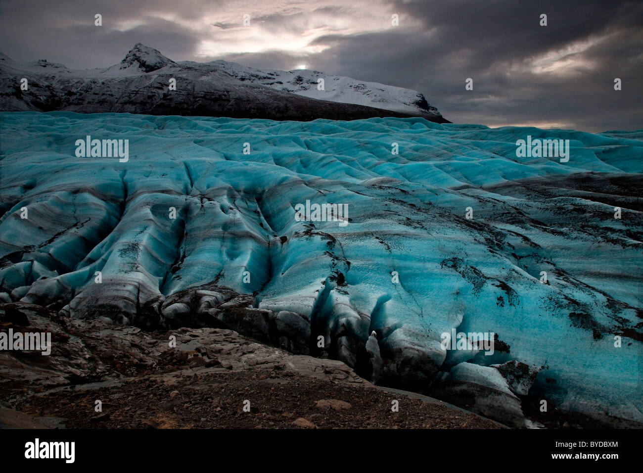 Large turquoise coloured glacier and thunderstorm clouds, Iceland ...