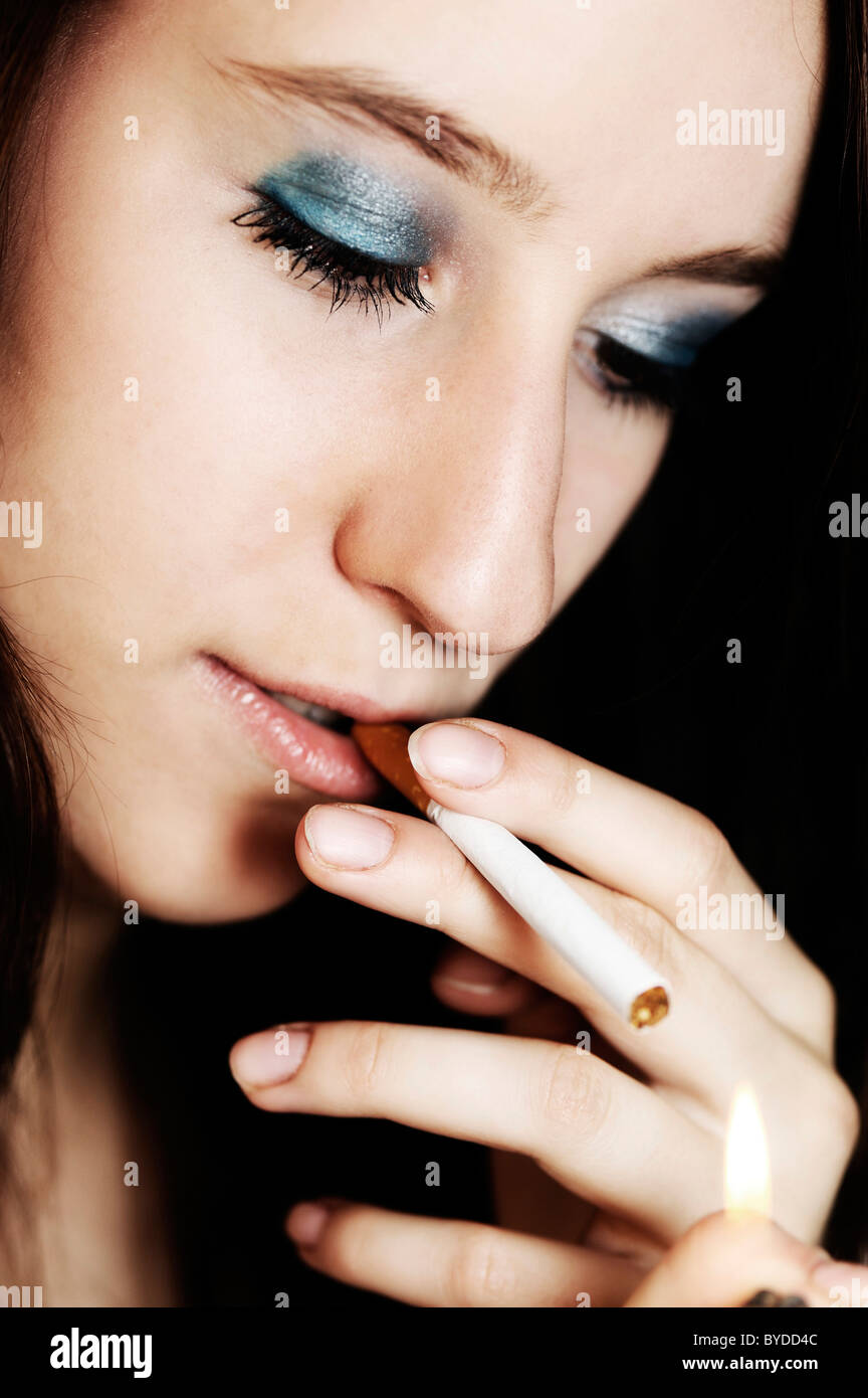 Close up woman lighting cigarette hi-res stock photography and images ...