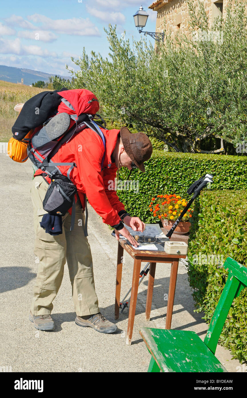 Pilgrim stamping his pilgrim's badge, pilgrim station, Camino de ...