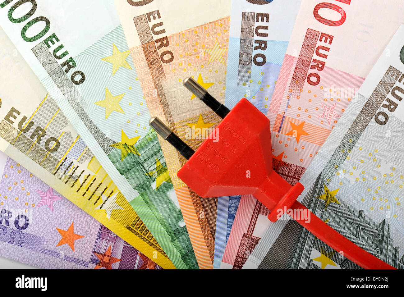 Power plug on a fan of various euro banknotes, symbolic image for ...