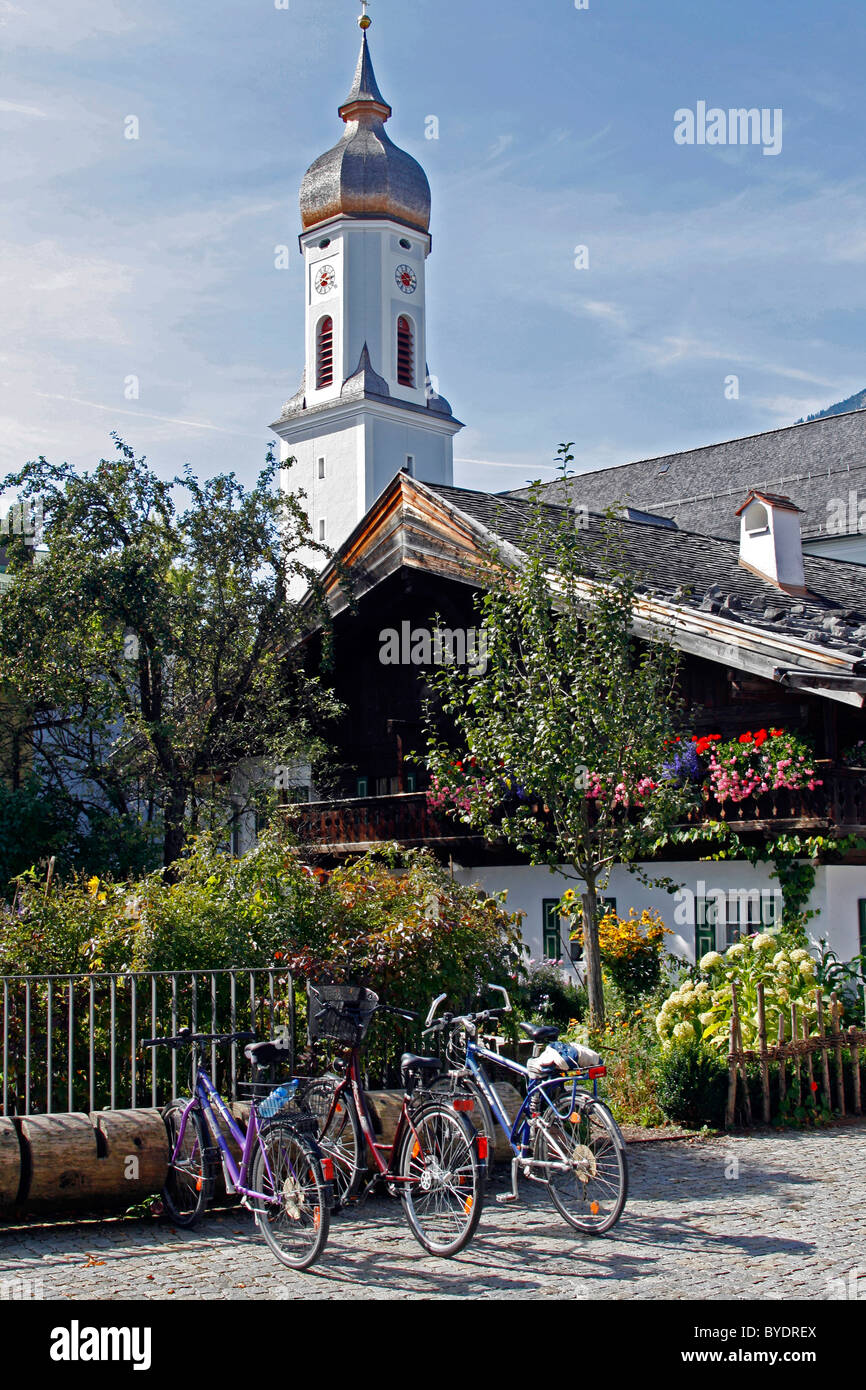 Traditional Bavarian buildings with balconies and flowers, a church ...